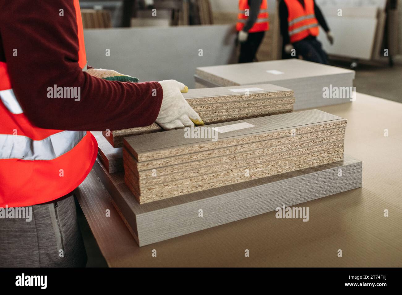 A worker prepares PVC furniture boards for packaging. Close-up ...