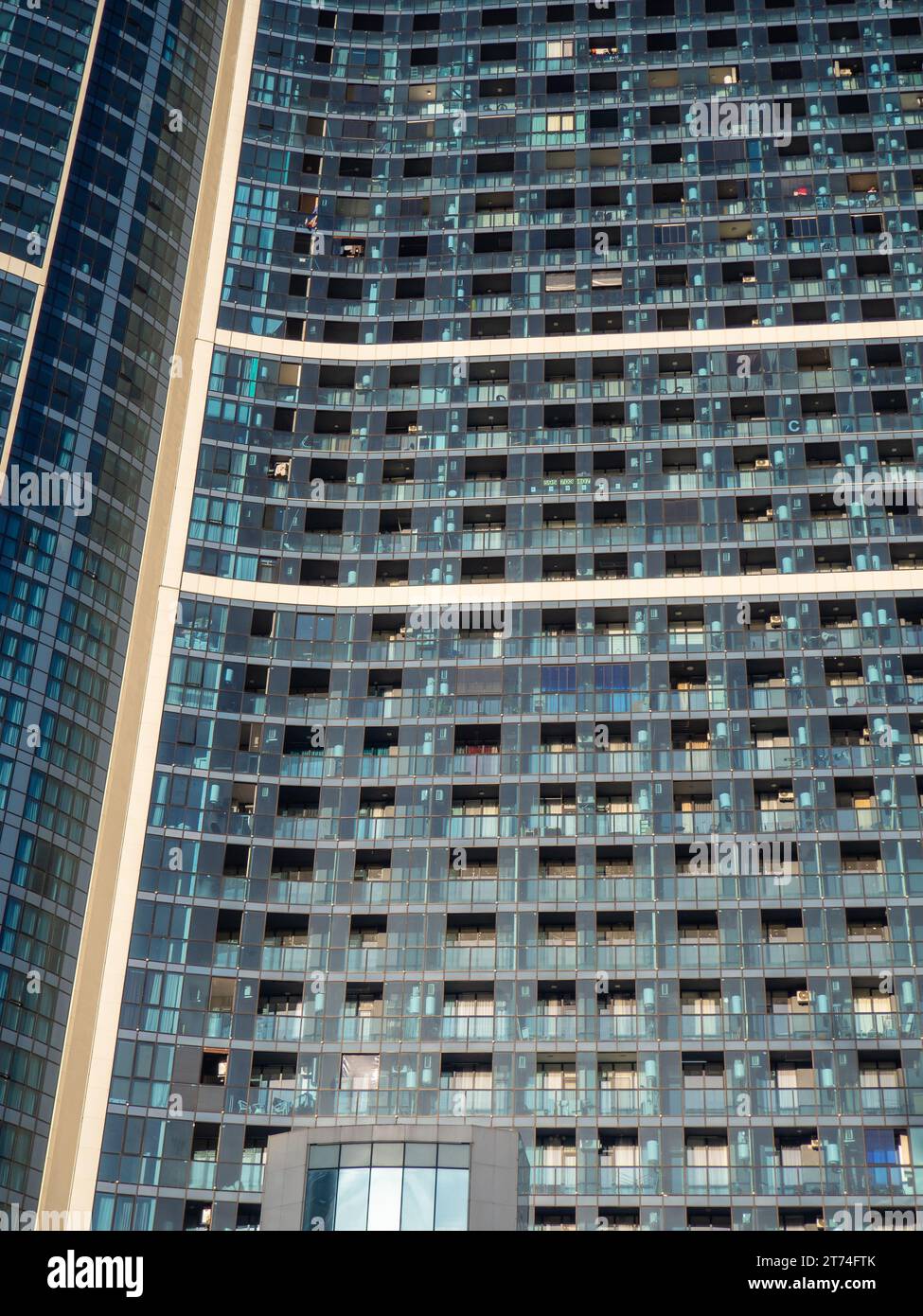 Glass facade of a house under construction with open windows. Windows ...