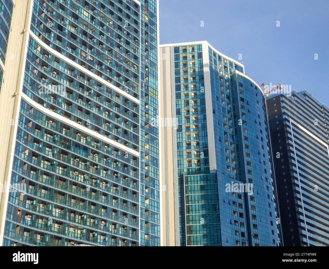 Glass facade of a house under construction with open windows. Windows ...