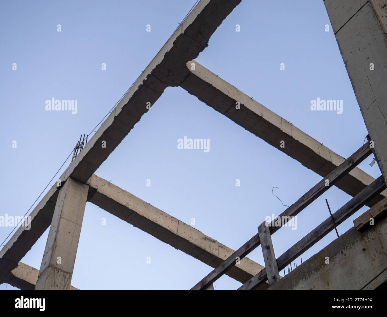 Structure made of concrete piles. Frame of a house under construction. Stone beams. Remains of ...