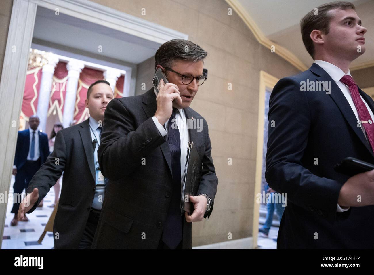 House Speaker Mike Johnson (R-La.), flanked by his security detail ...