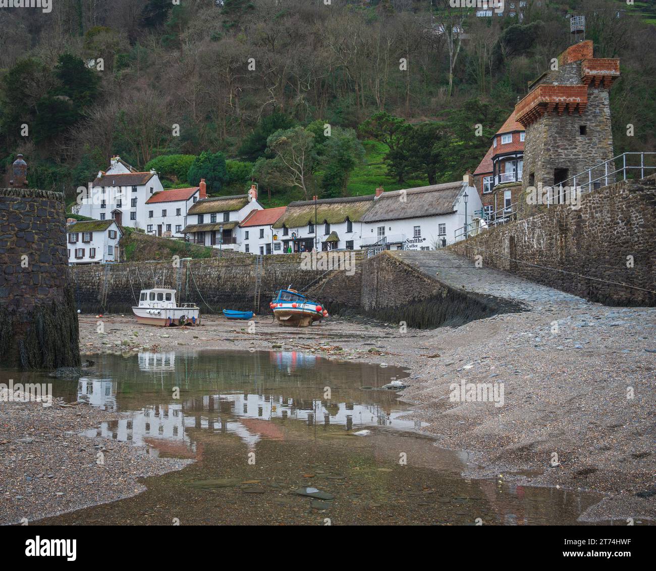 Fishing boats left high and dry at low tide in the harbour at Lynmouth ...