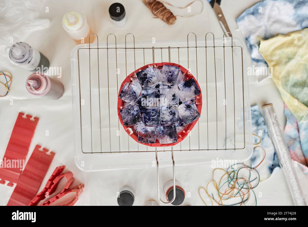 Top view of round liner with crumpled t-shirt inside and ice cubes ...