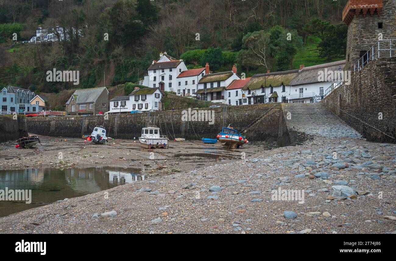 Fishing boats left high and dry at low tide in the harbour at Lynmouth ...