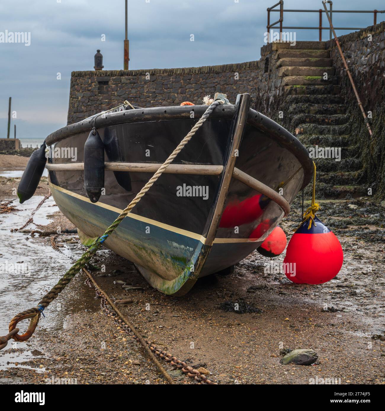 Fishing boats left high and dry at low tide in the harbour at Lynmouth ...