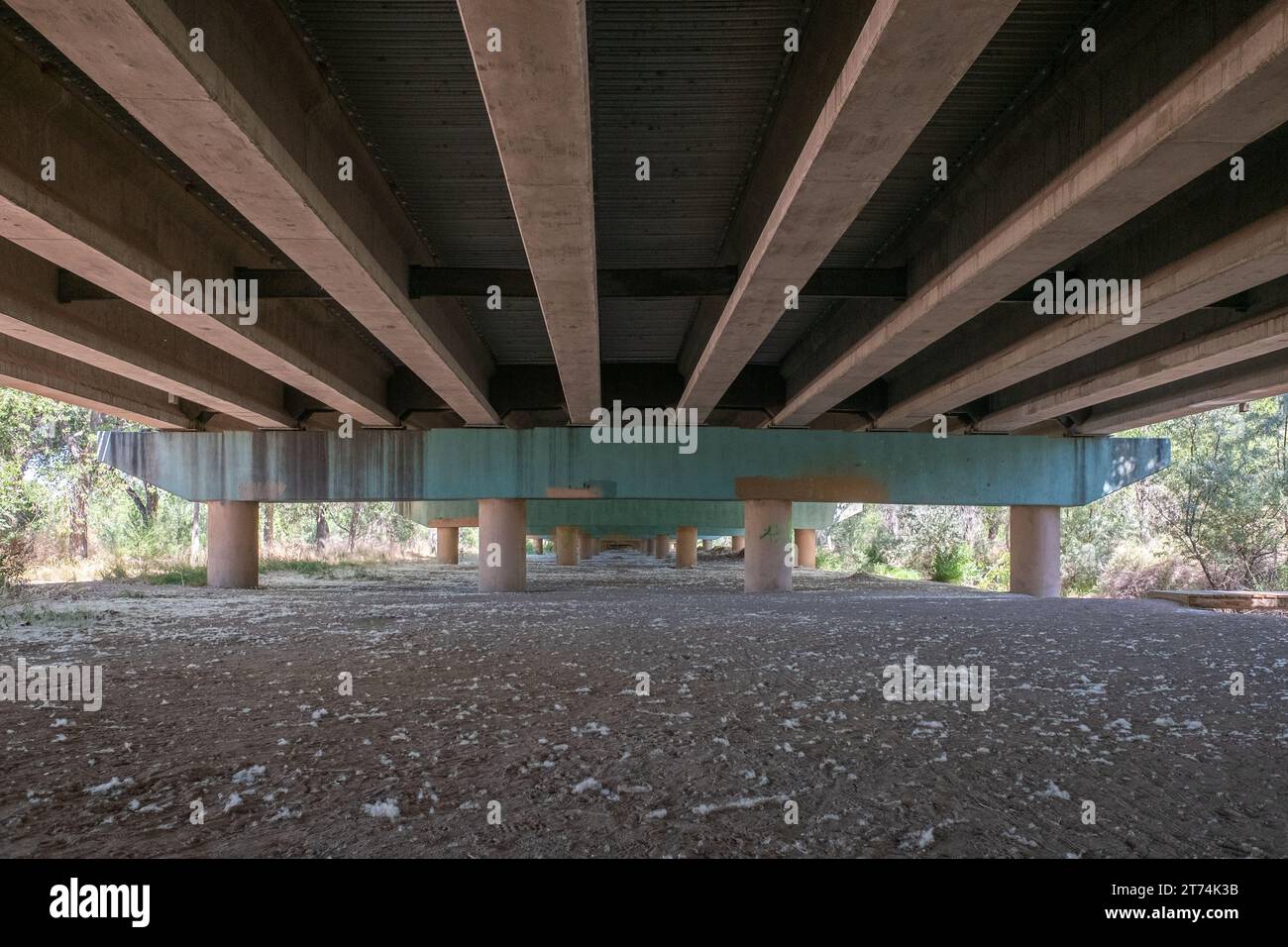 Beneath a highway overpass at a low angle. The overpass disappears into ...