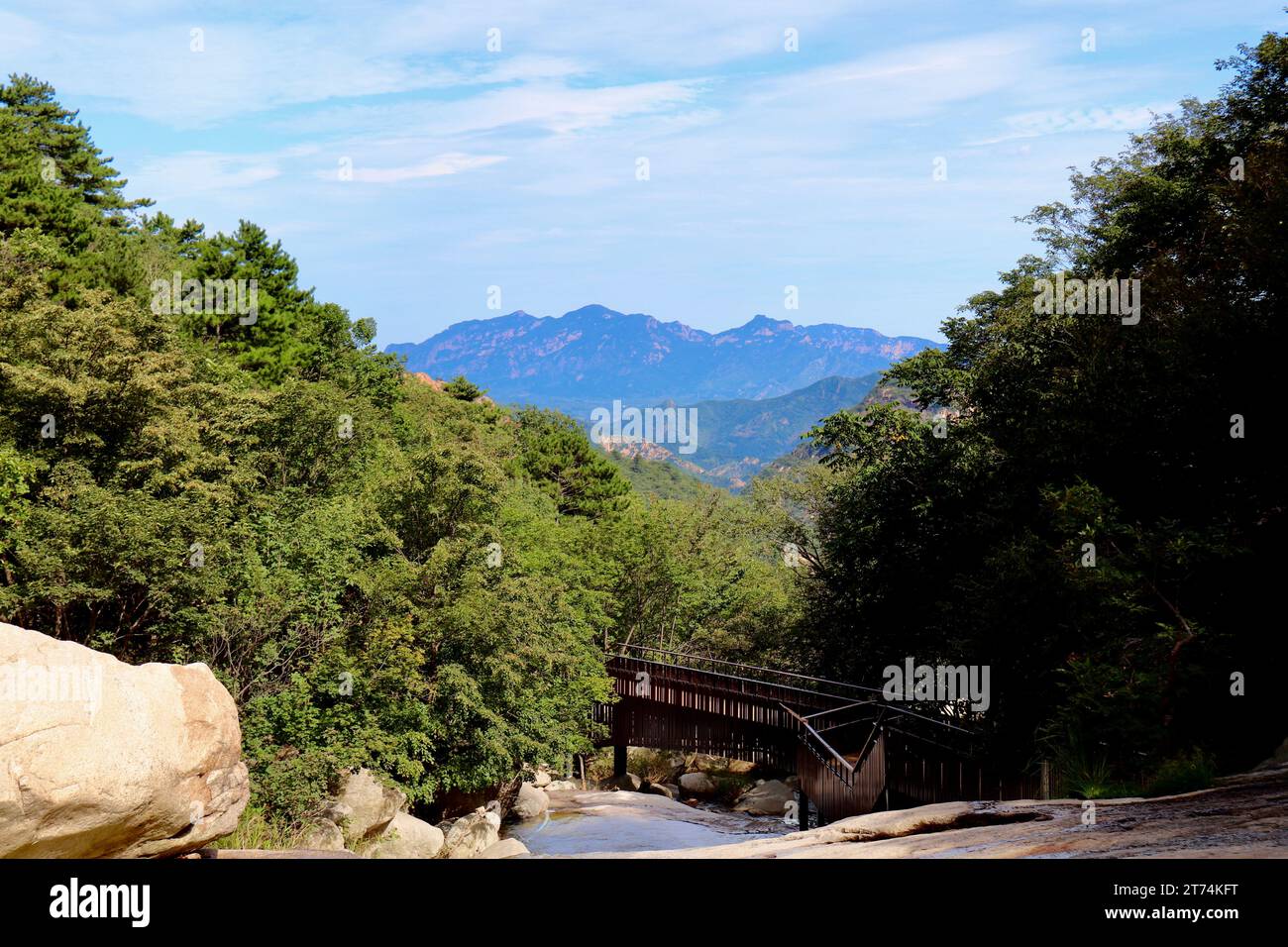 A scenic landscape featuring a winding road passing beneath a majestic ...