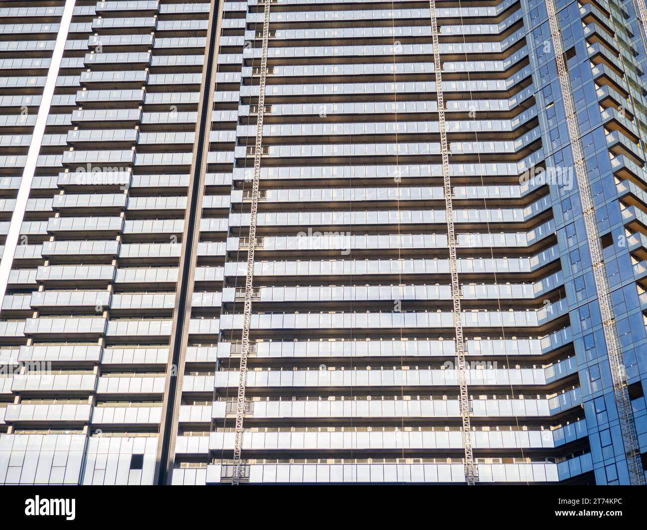 Glass facade of a house under construction with open windows. Windows ...