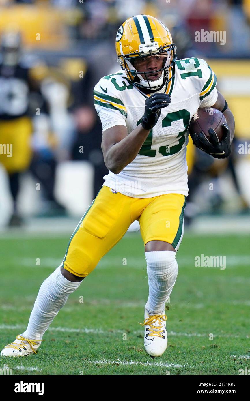 Green Bay Packers wide receiver Dontayvion Wicks carries the ball ...