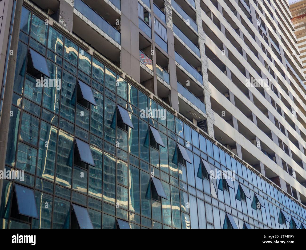Glass facade of a house under construction with open windows. Unwashed ...