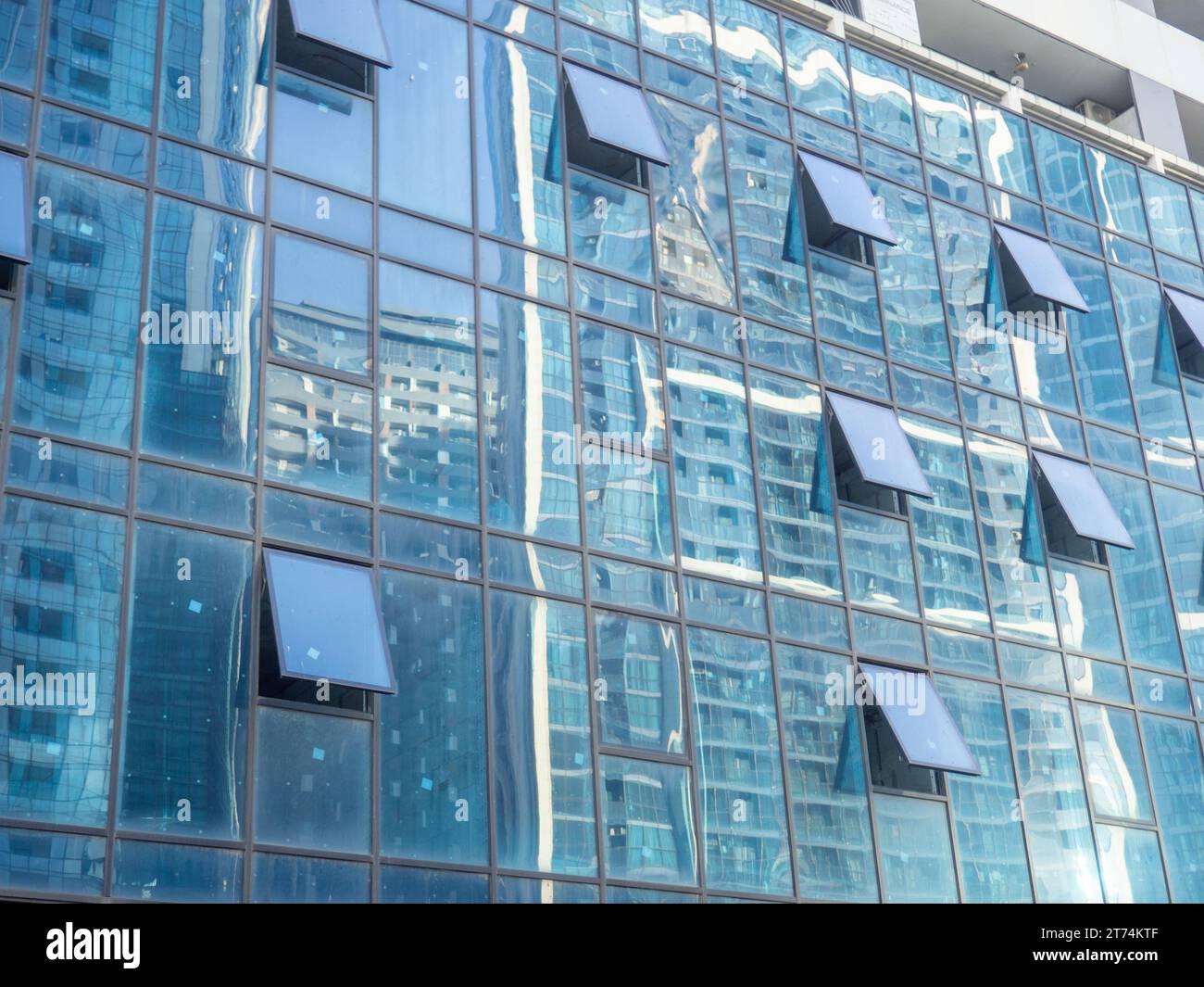 Glass facade of a house under construction with open windows. Unwashed ...
