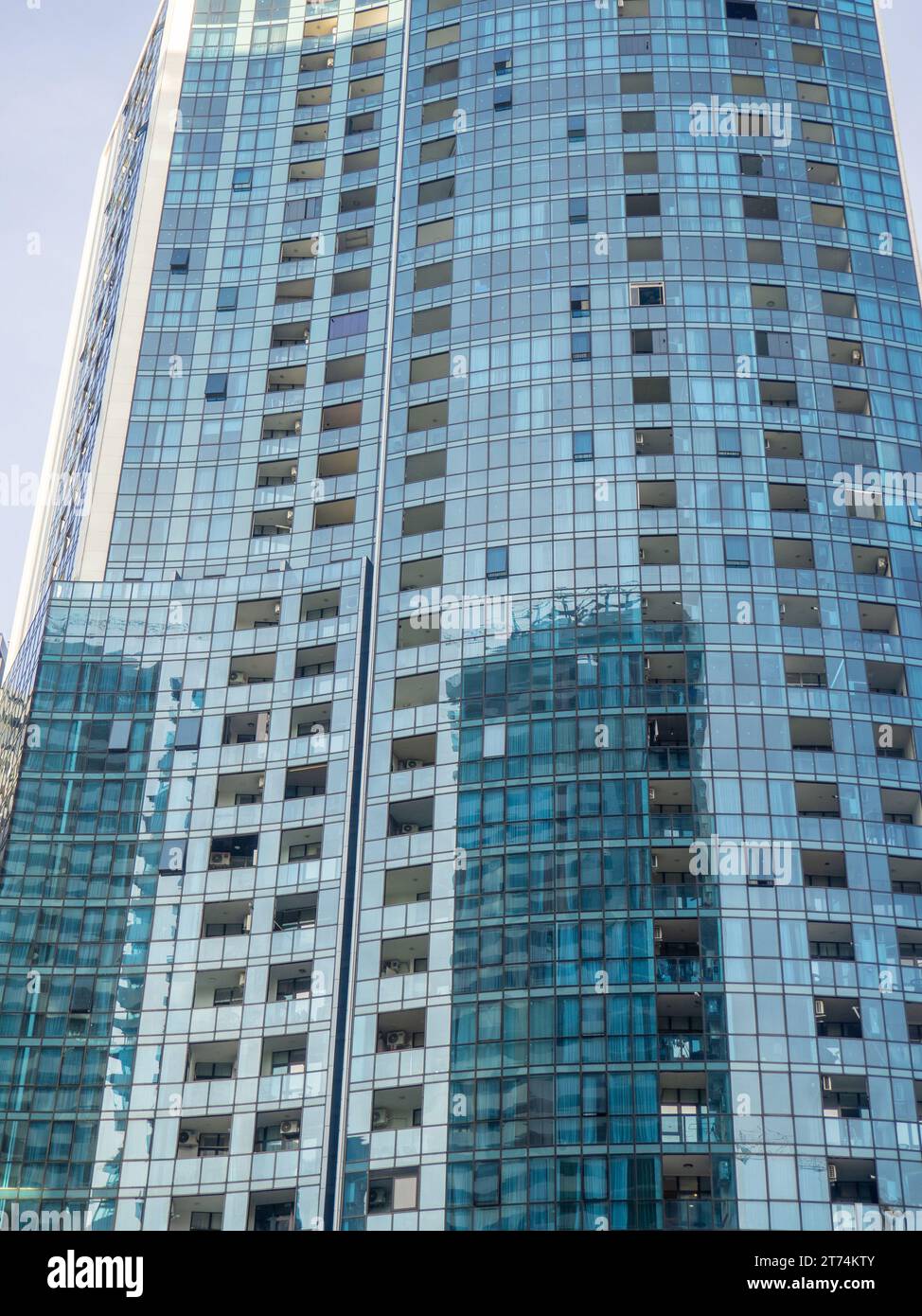 Glass facade of a house under construction with open windows. Windows ...