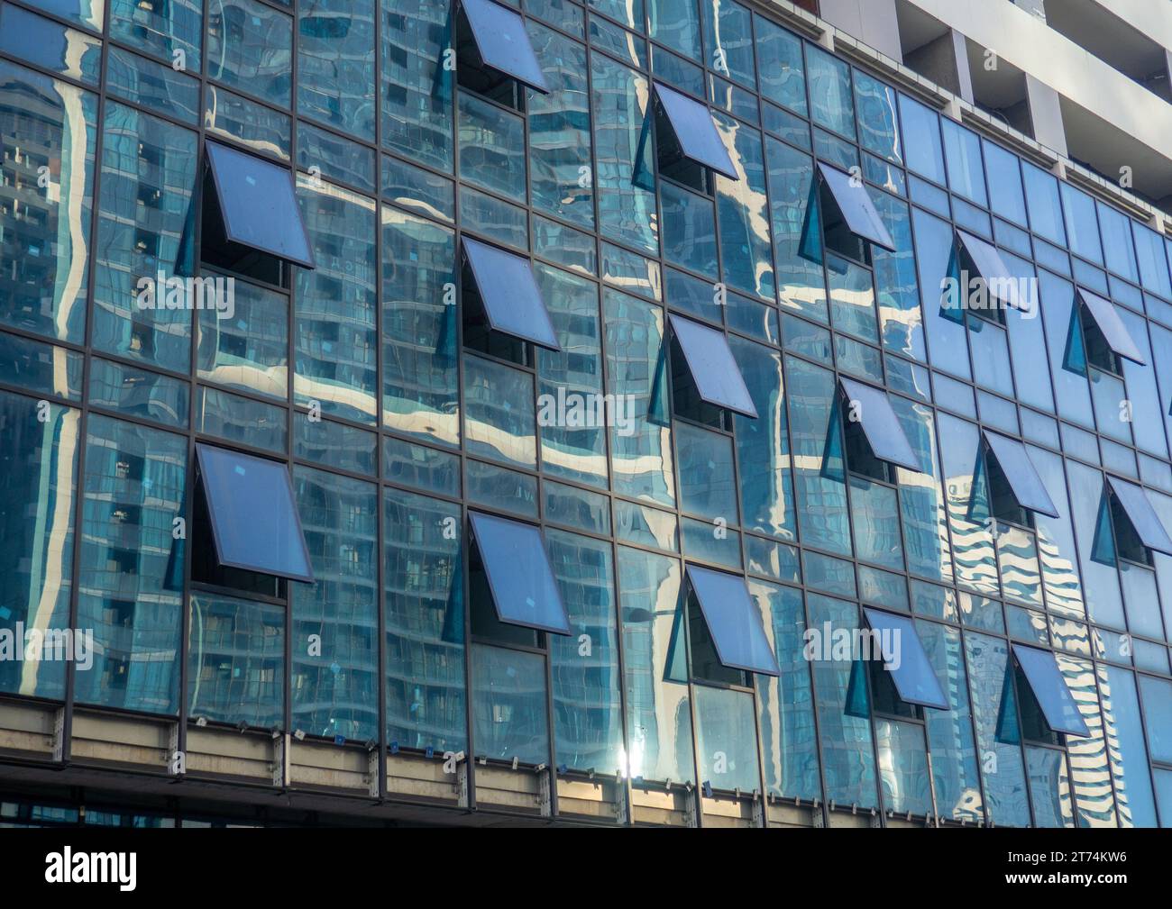 Glass facade of a house under construction with open windows. Unwashed ...