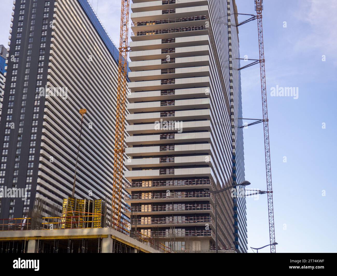 Glass facade of a house under construction with open windows. Windows ...