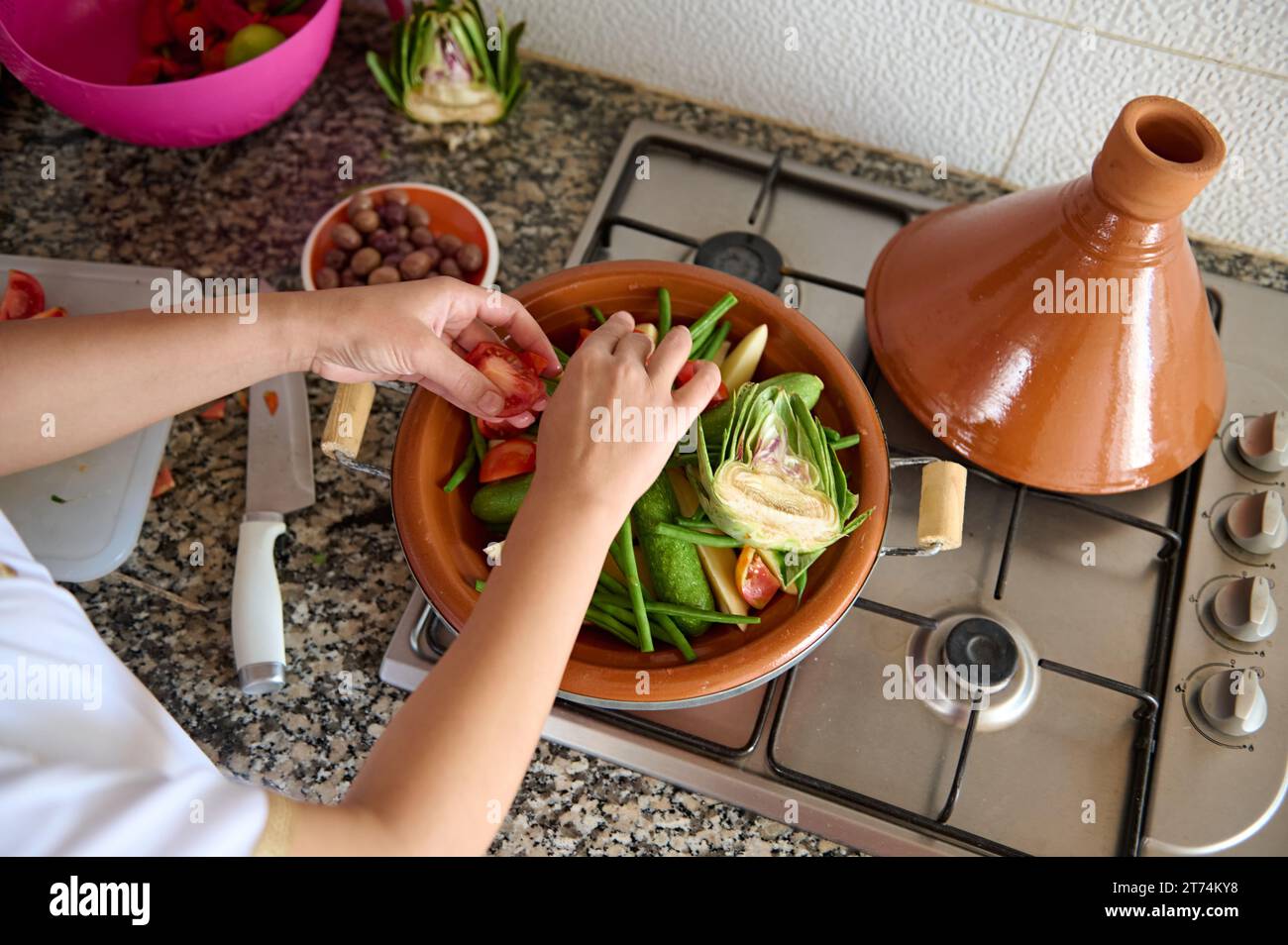 View from above of Muslim housewife cooking delicious vegetarian meal ...
