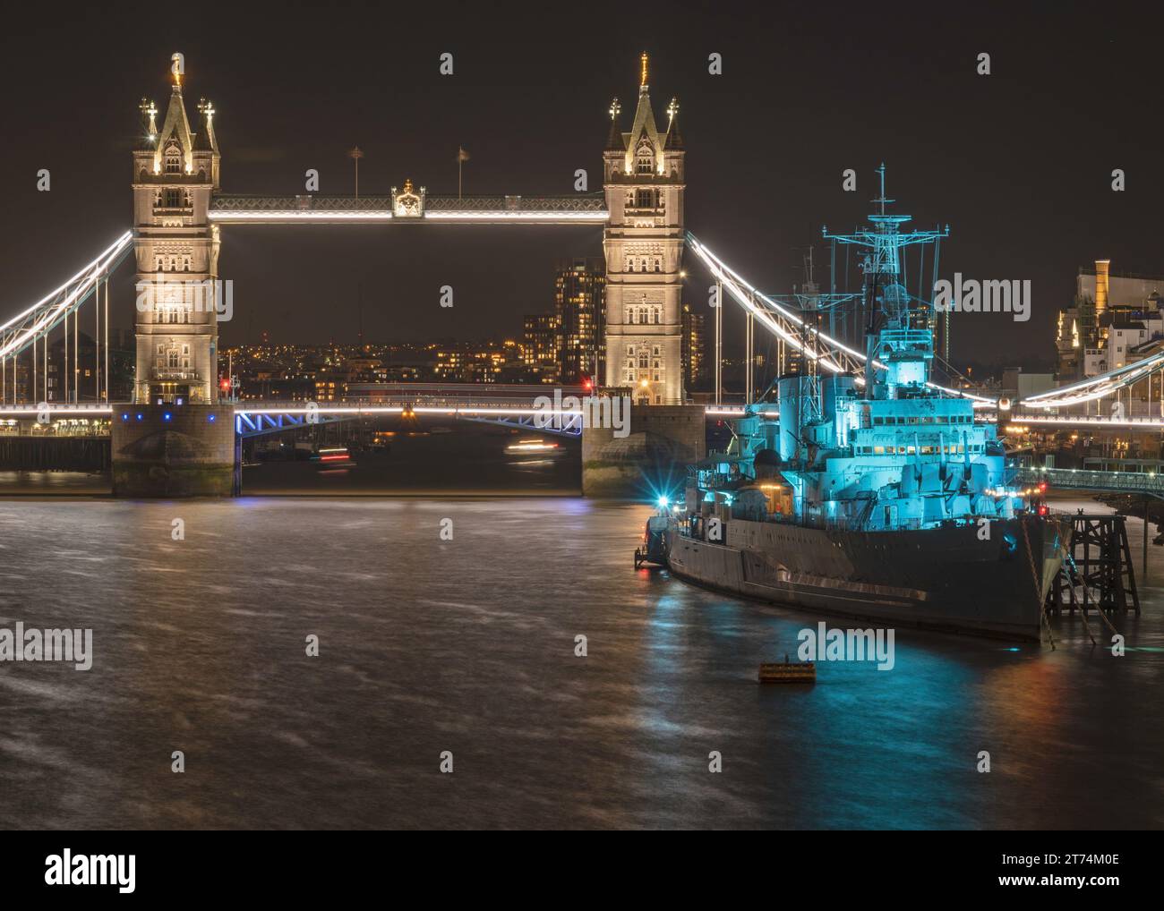 HMS Belfast lit up at night with Tower Bridge in the background ...