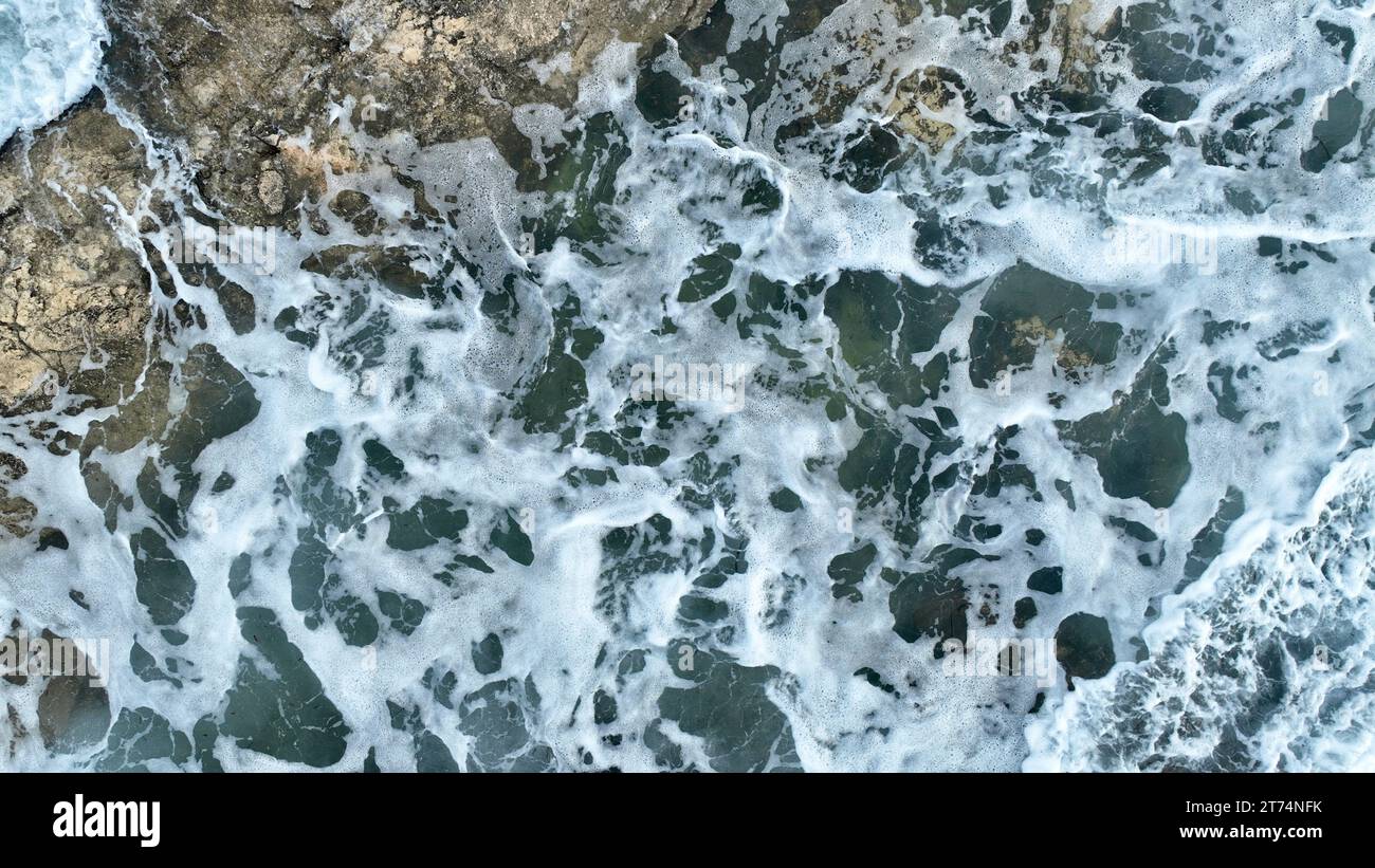 Aerial view of sea waves hitting the rocks with drone high quality ...