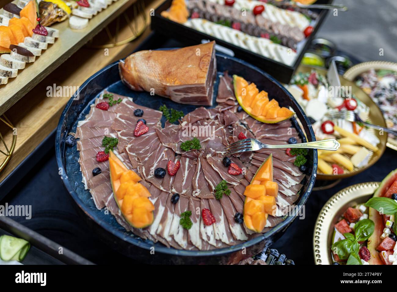 Cold meat delicatessen snacks, Italian prosciutto on round black dish ...