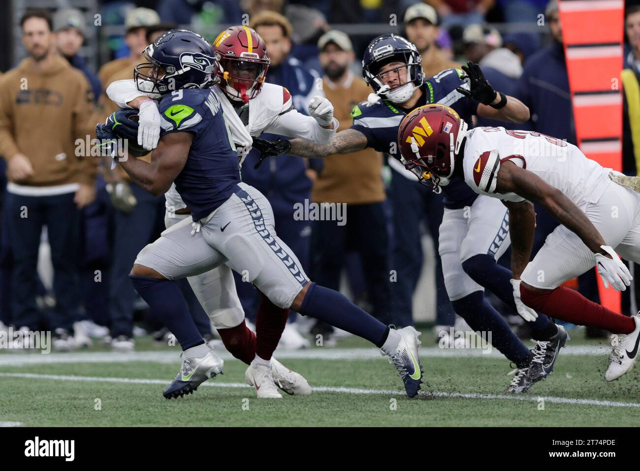 Seattle Seahawks running back Kenneth Walker III is hit from behind by ...