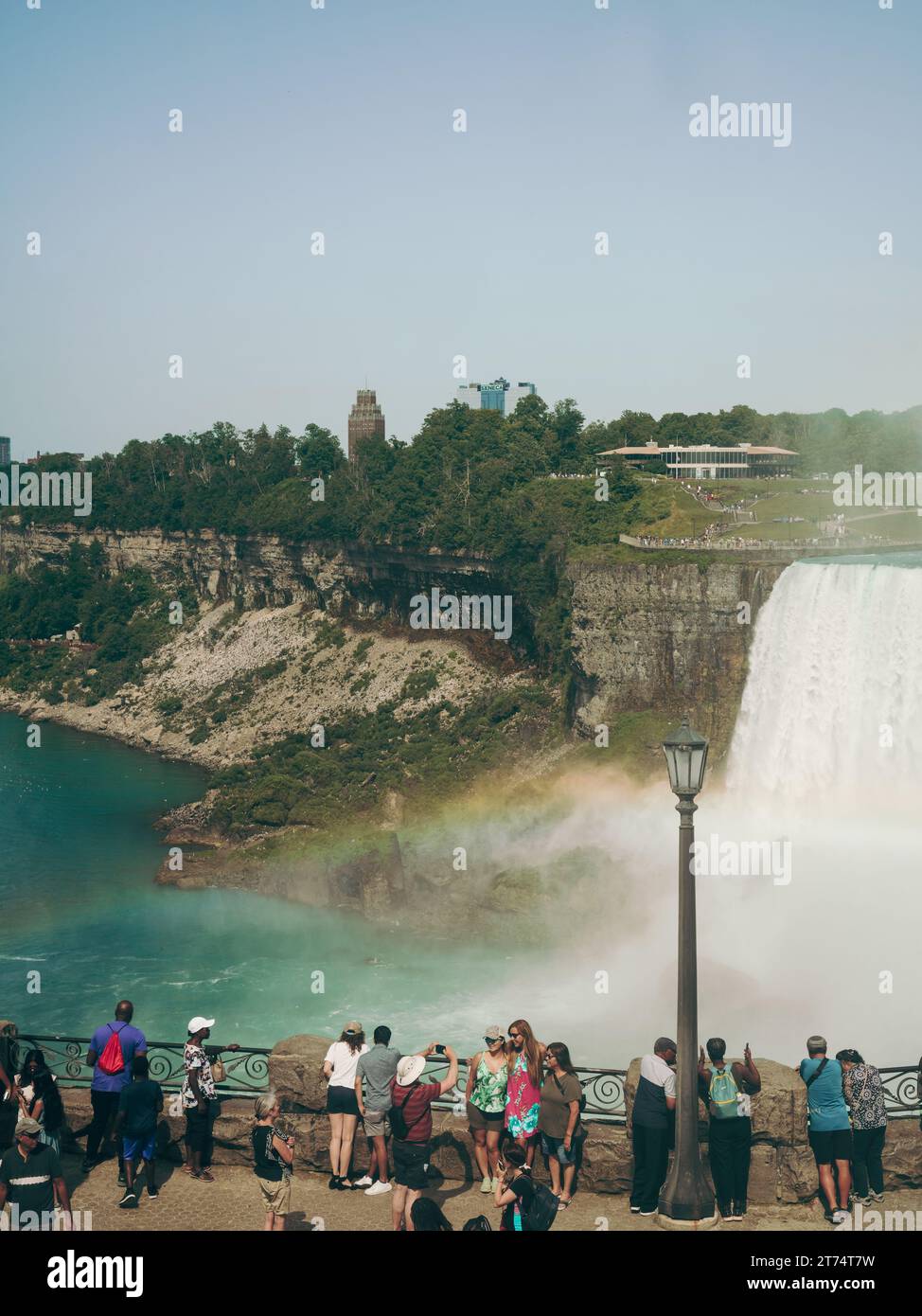 A diverse group of people stands together at the edge of a magnificent ...