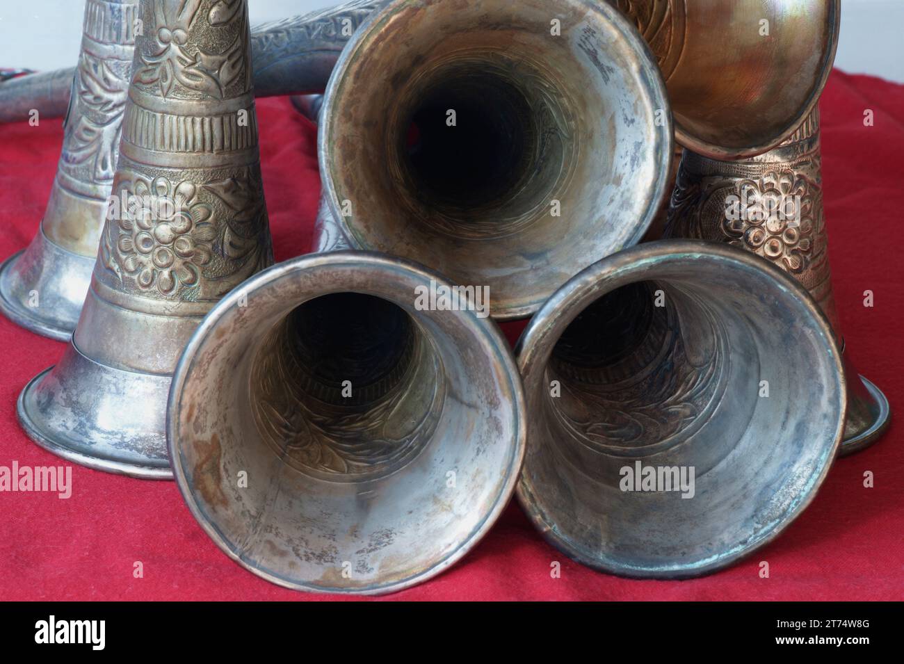 Trumpet duty bugle horns show intricate stamped silver color design, a ...