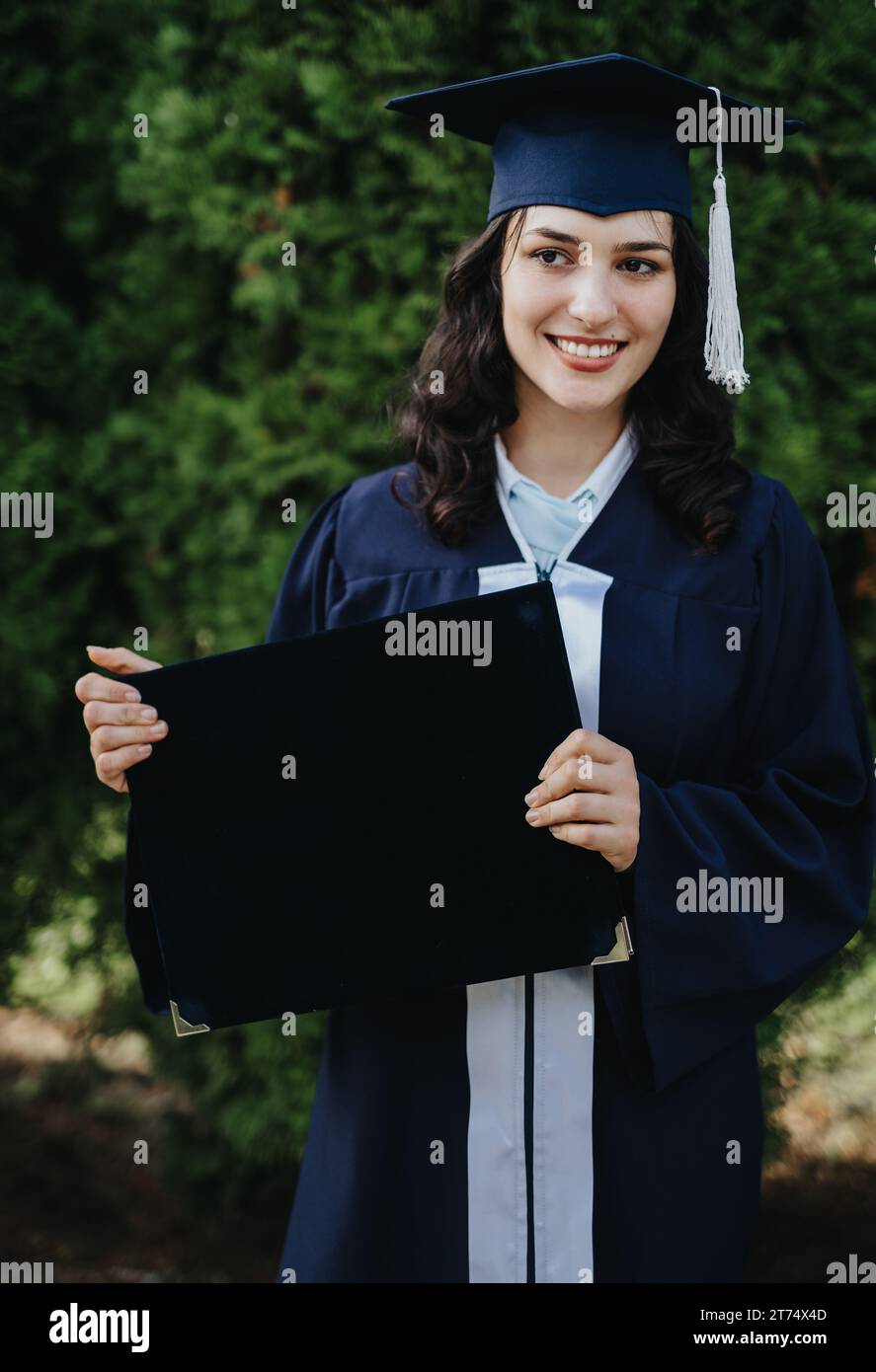 A female student celebrating her academic success, posing happily in ...