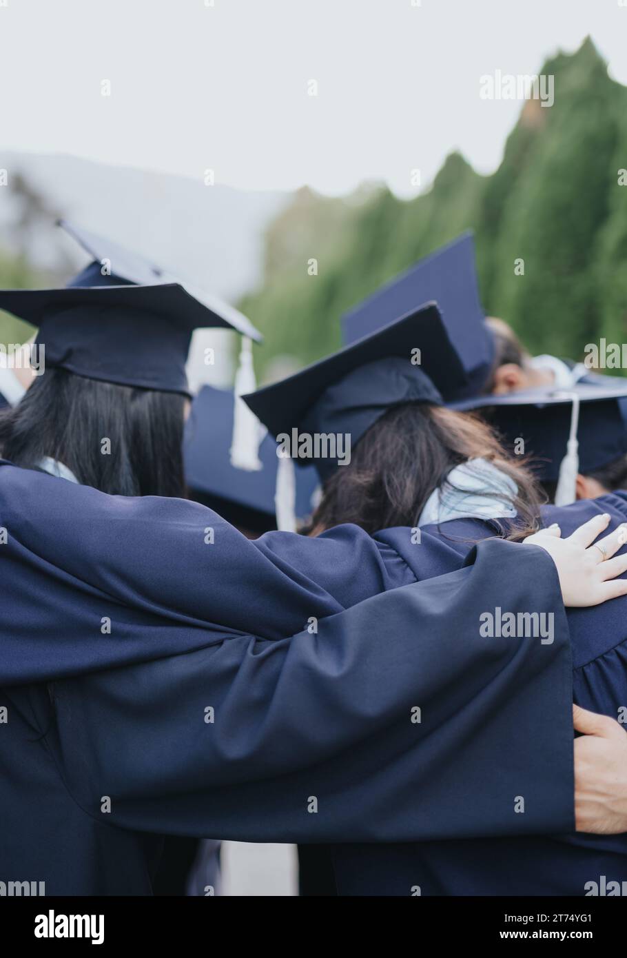 Successful students stand in a circle after they graduated from college ...
