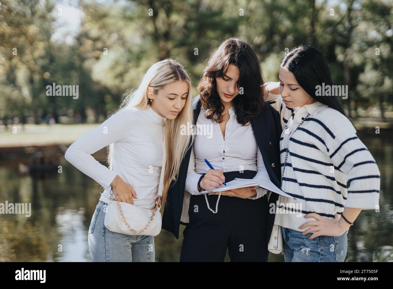 University students studying and discussing subjects outdoors ...