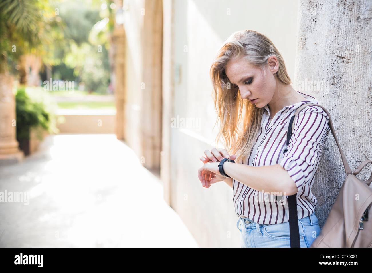 Close up blonde young woman checking her time watch Stock Photo - Alamy
