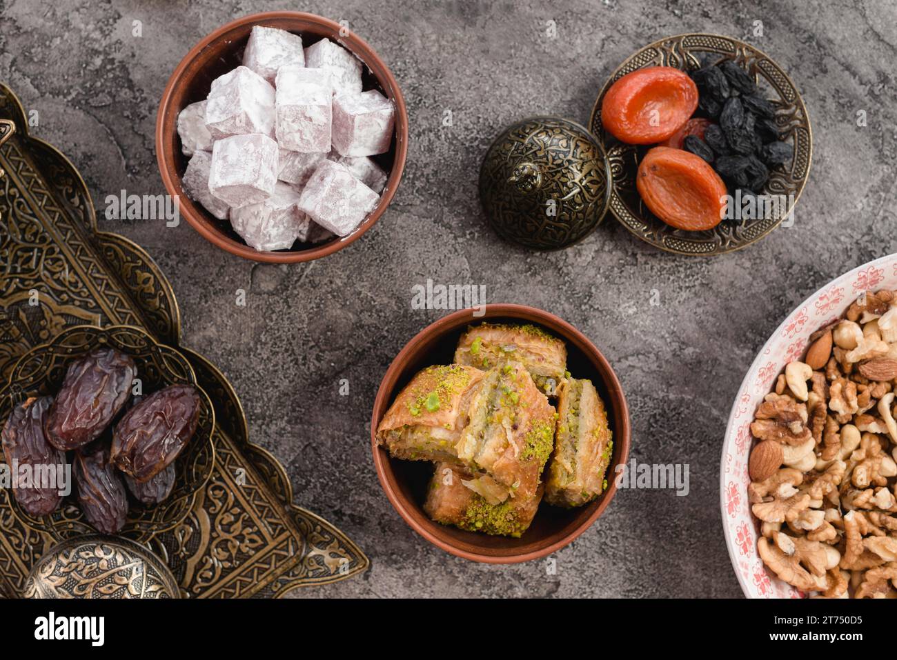 Earthen bowl lukum baklava dates nuts dried fruits gray concrete Stock ...