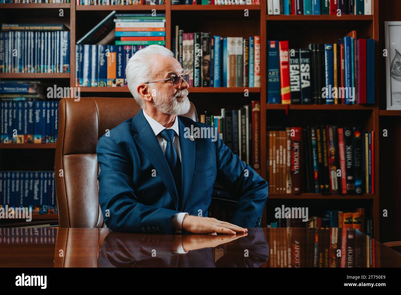 Confident university rector posing with academic books. Mature and ...
