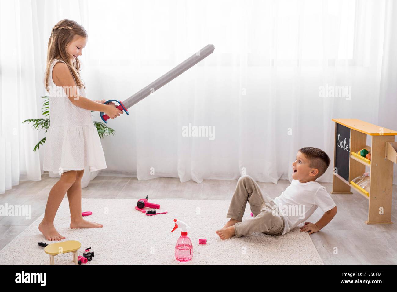Kids playing with sword toys Stock Photo - Alamy