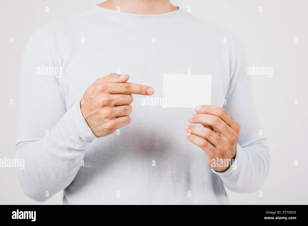 Hand holding business card pointing finger Stock Photo - Alamy