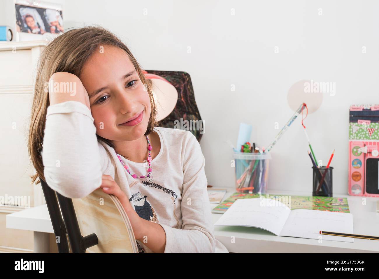Upset girl doing homework Stock Photo - Alamy