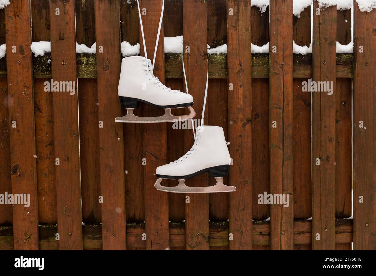 Skates hanging wooden fence Stock Photo - Alamy