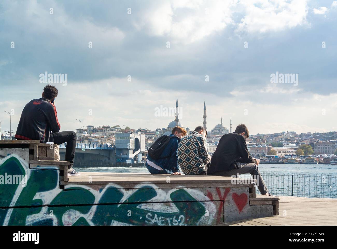 Istanbul, Turkey, People relaxing at a waterfront of Karakoy ...