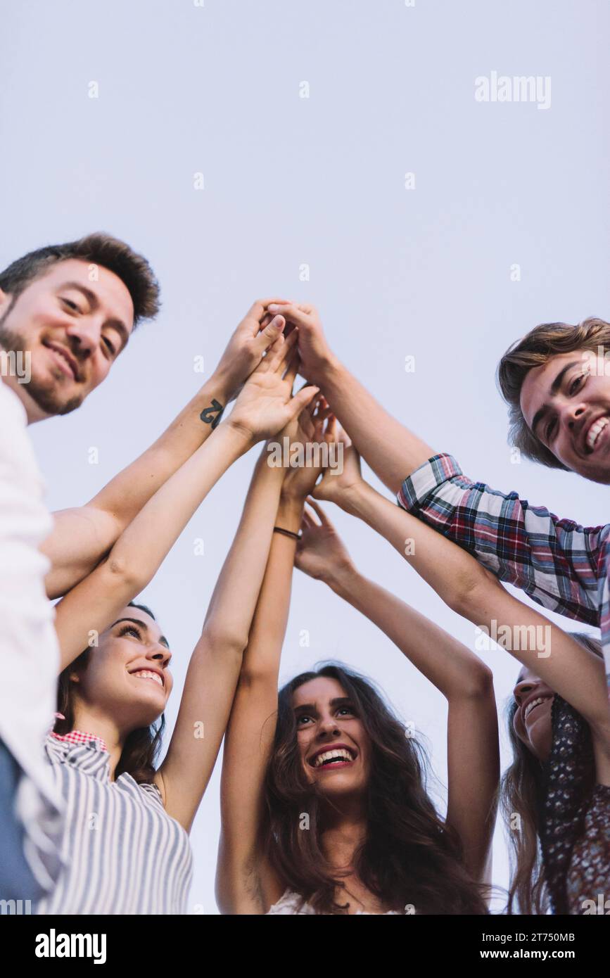 Group friends clapping hands Stock Photo - Alamy