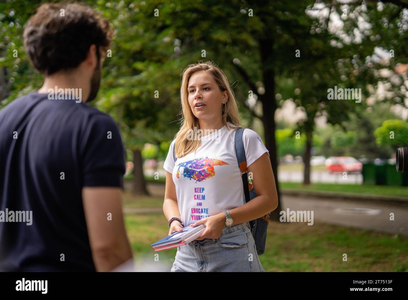 College students discussing at the park, exchanging ideas and solutions ...