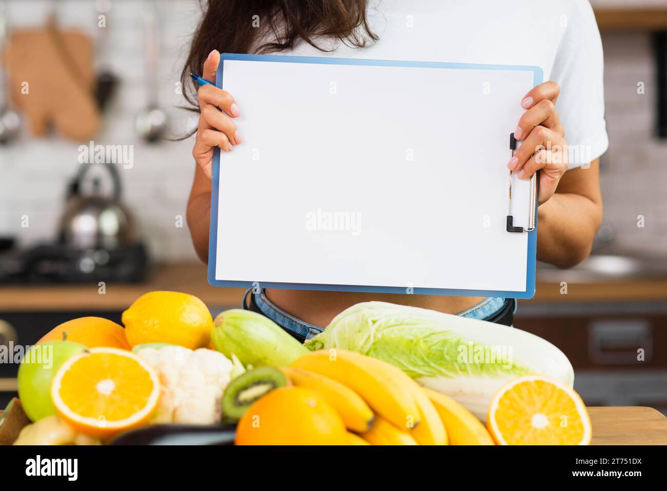 Close up person holding up clipboard Stock Photo - Alamy