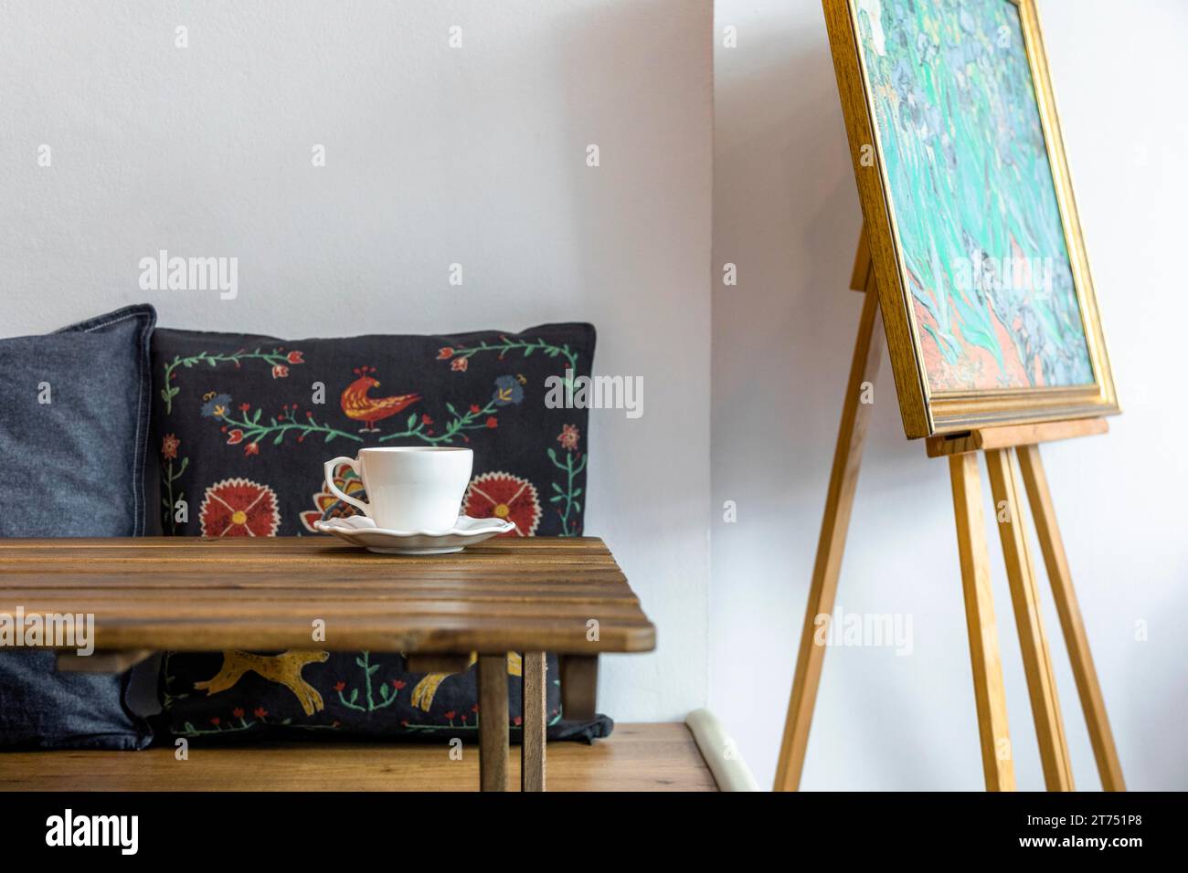 Coffee cup saucer wooden table front cushion easel Stock Photo - Alamy