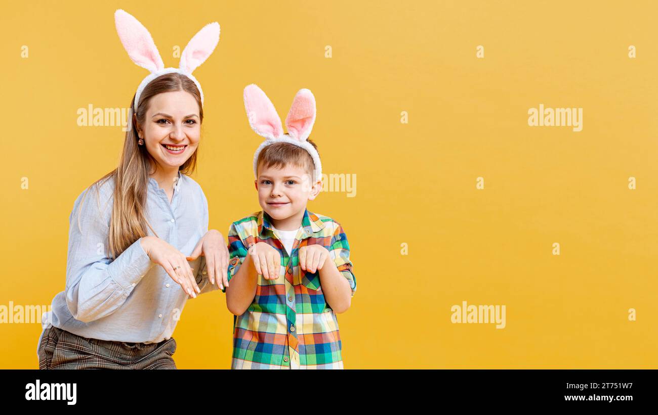 Copy space mother son imitating rabbit Stock Photo - Alamy