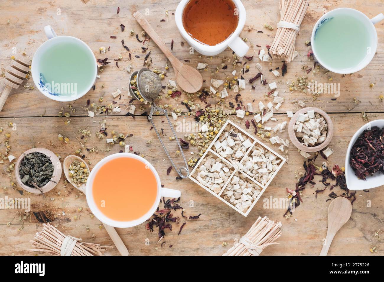 Different types tea ceramic cup with herbs honey dipper Stock Photo - Alamy