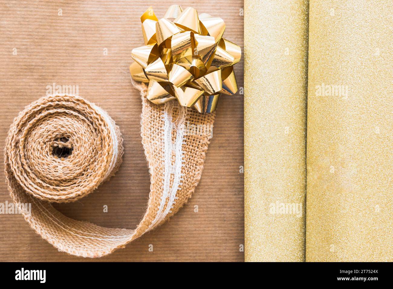 Elevated view weaving ribbon golden bow with shiny gift paper Stock ...
