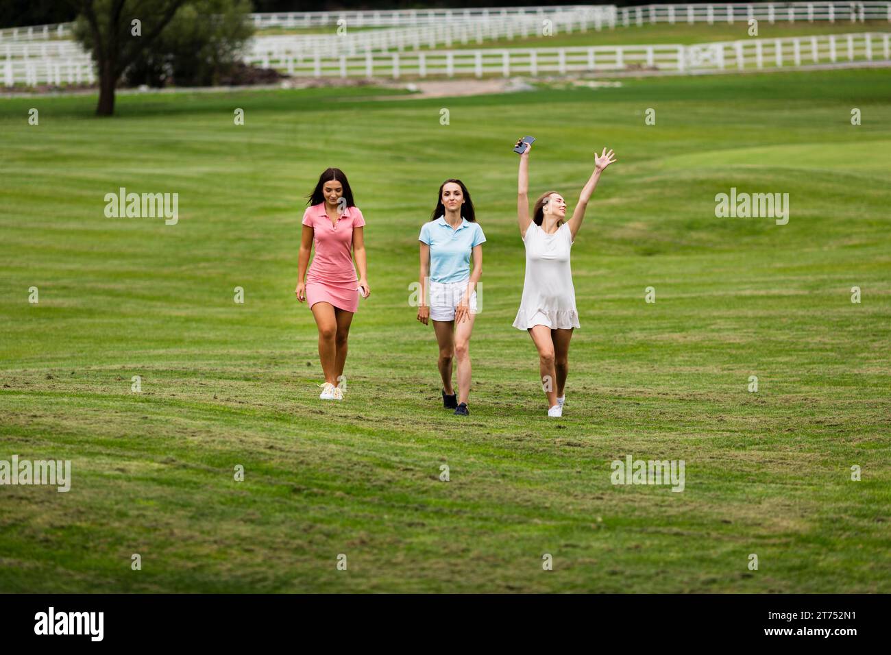 Full shot group women golf course Stock Photo - Alamy