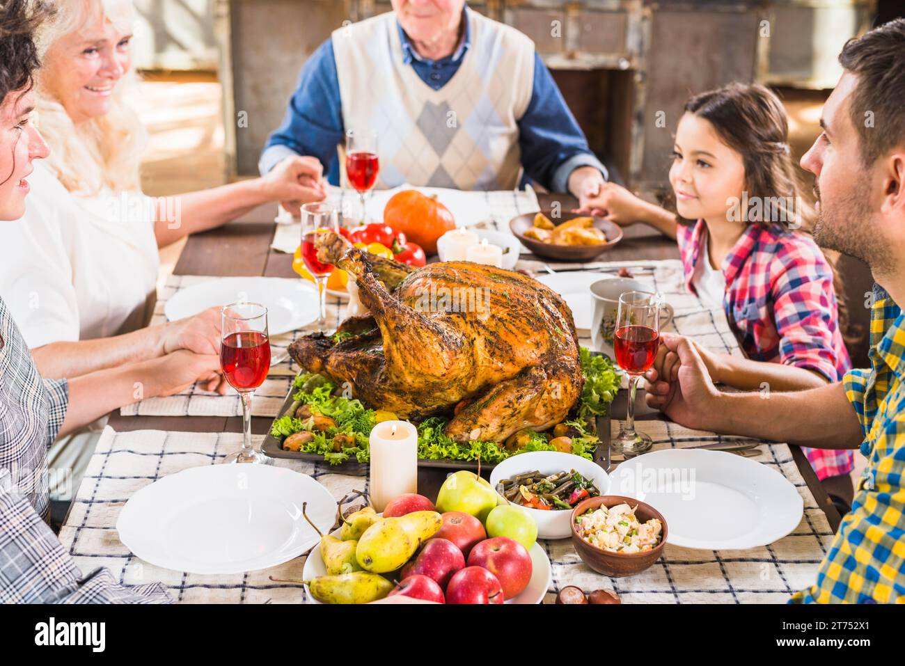 Happy family holding hands table Stock Photo - Alamy