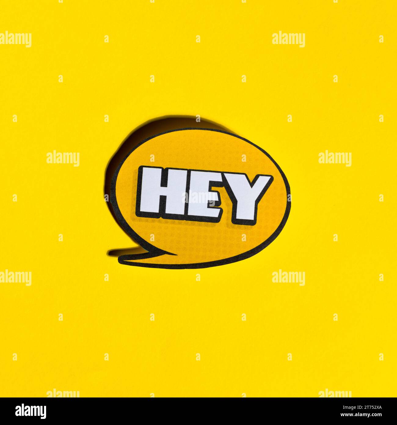 Hey speech bubble yellow backdrop Stock Photo - Alamy