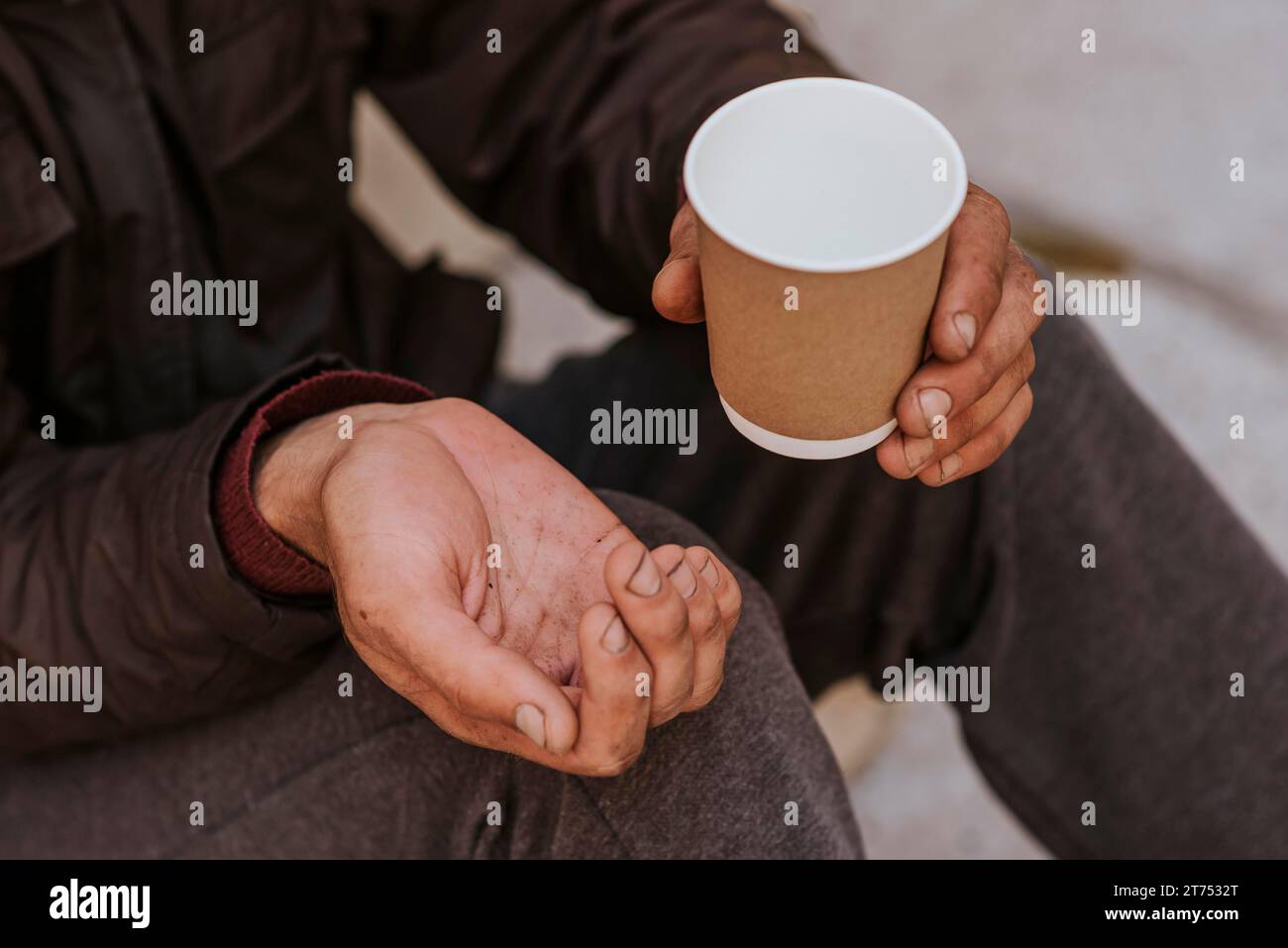 Homeless man holding hand out help empty cup Stock Photo - Alamy