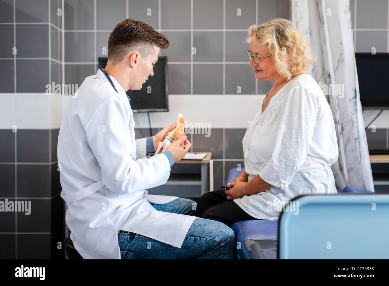 Lateral view doctor showing bone joints patient Stock Photo - Alamy