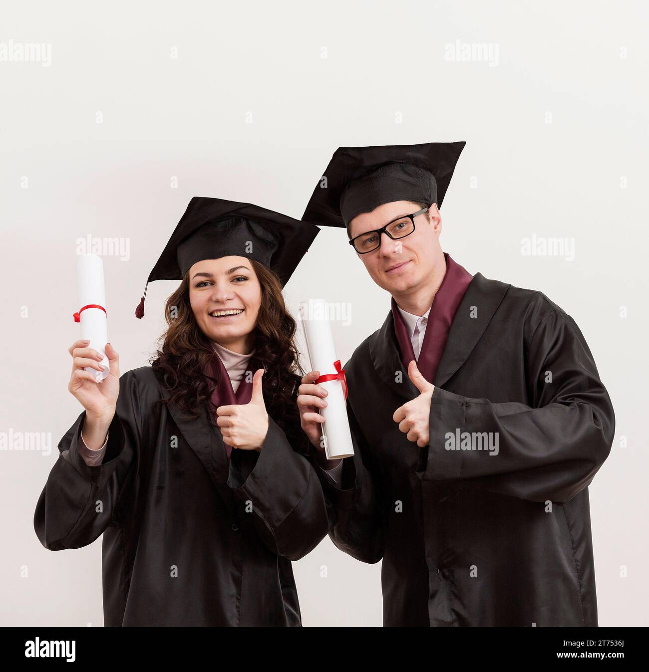 Medium shot happy graduate students Stock Photo - Alamy