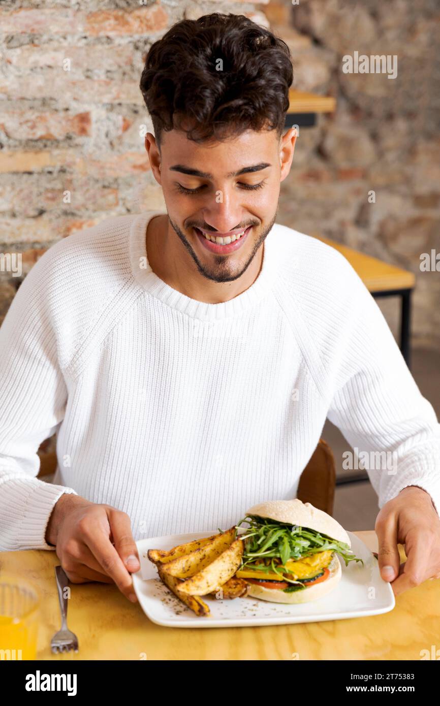 Medium shot man with delicious food Stock Photo - Alamy